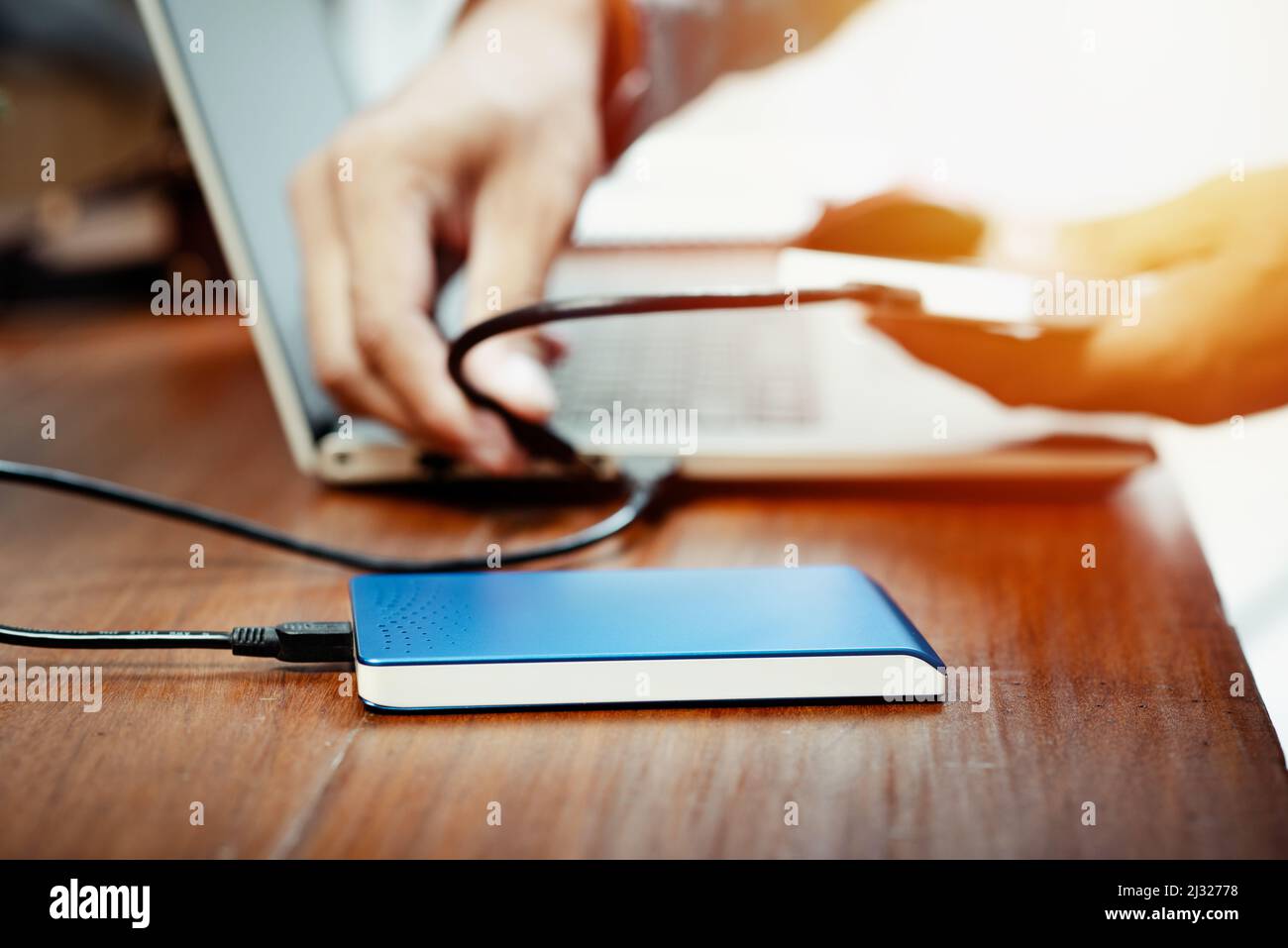 Closeup external hard drive on wooden desktop. Working with external ...