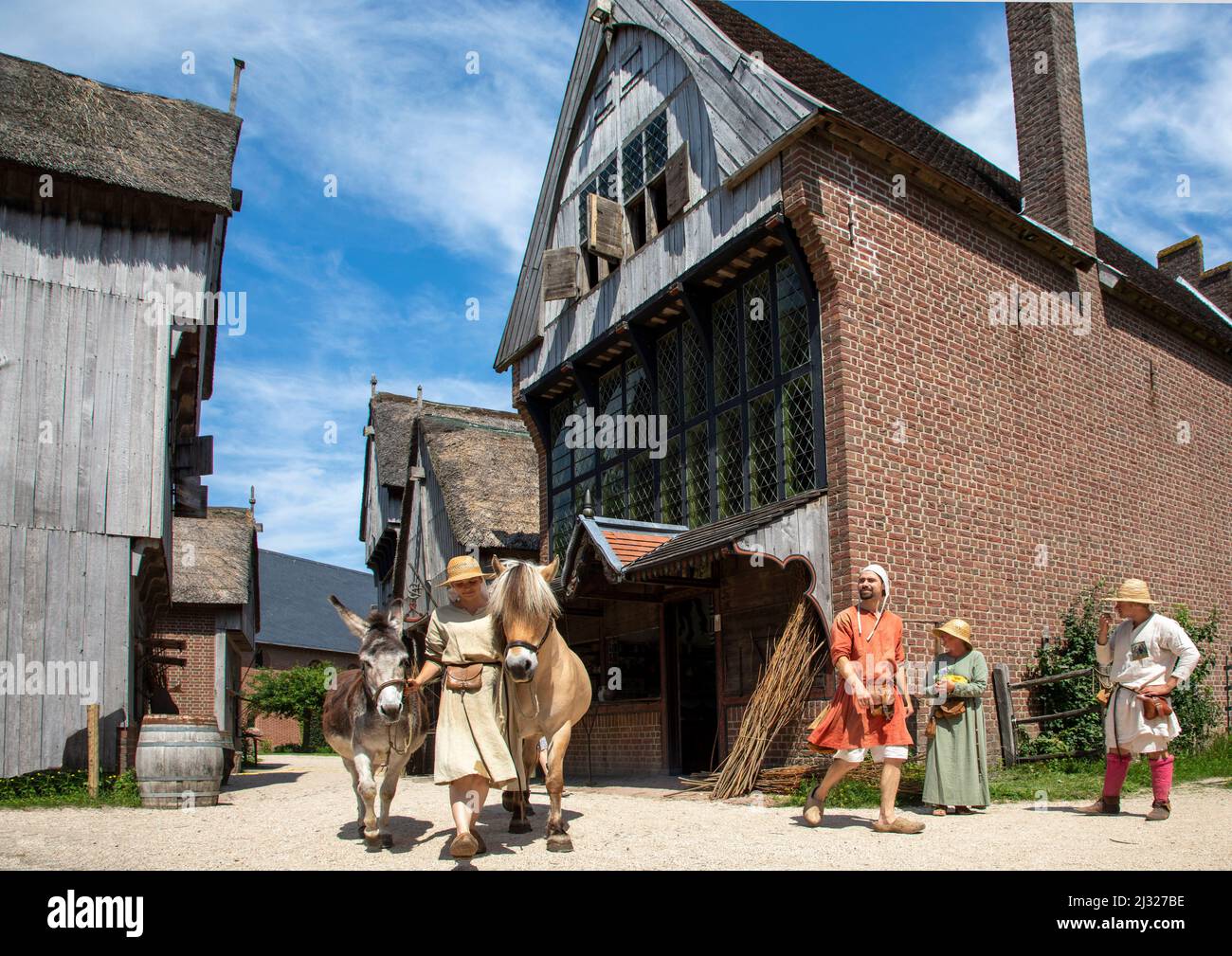 Netherlands, street in a Dutch city in the middle ages. Woman is ...