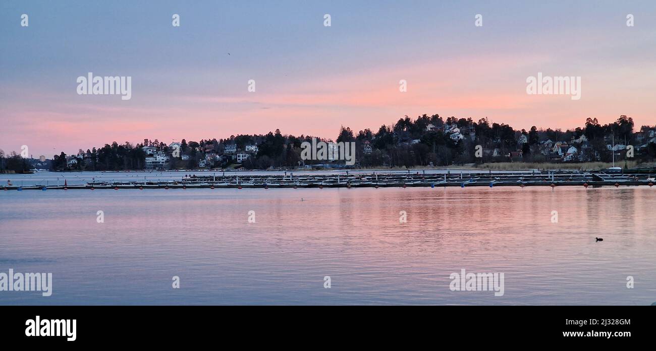 The view of the smooth water surface of the lake at sunset Stock Photo ...