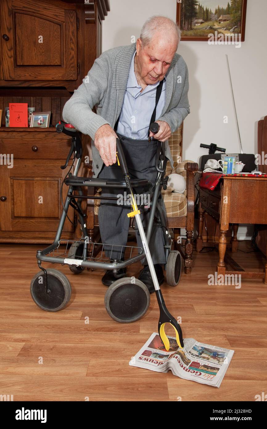 Netherlands, old man with a wheelchair and rollator is using the long ...