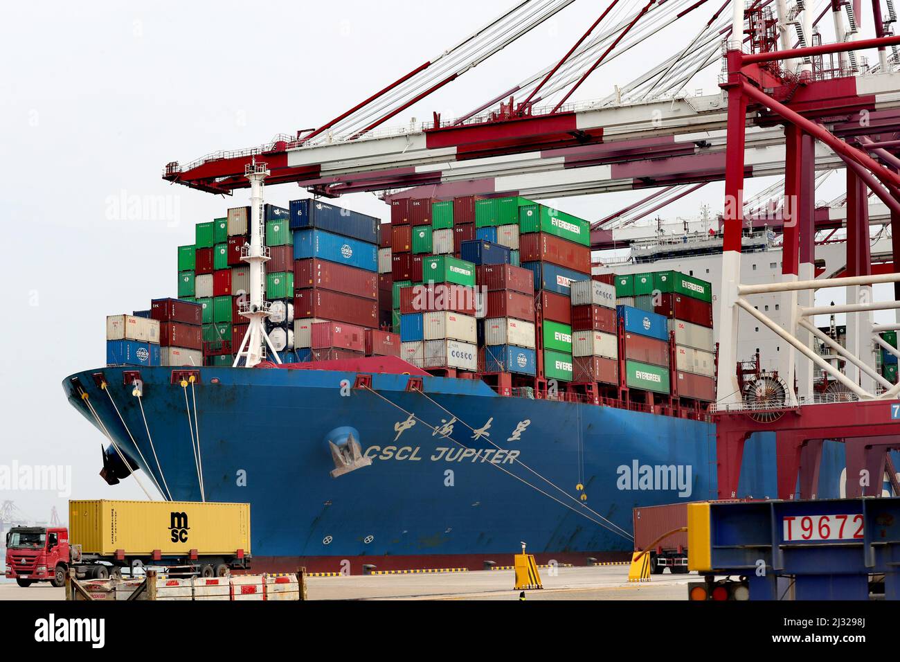 QINGDAO, CHINA - APRIL 5, 2022 - Freighters load and unload goods at ...