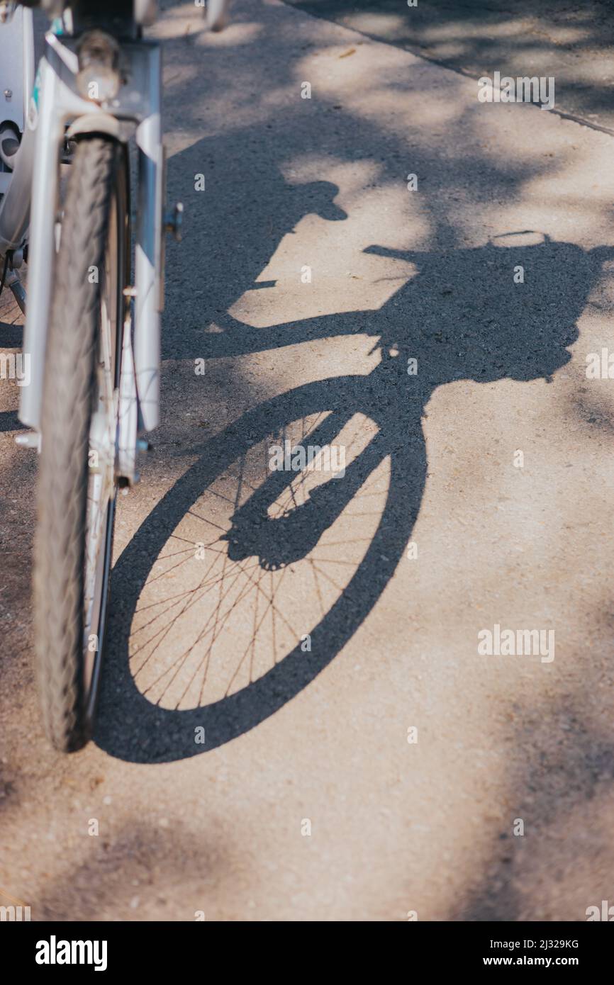 A vertical closeup of the bike parked on the street. The shadow falling ...