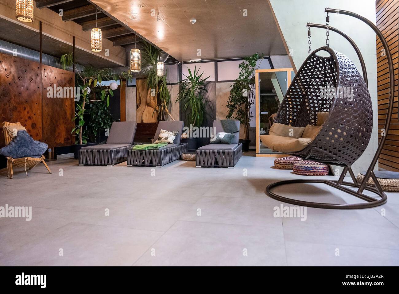 Empty lounge and swing chairs in spa center against background of ...
