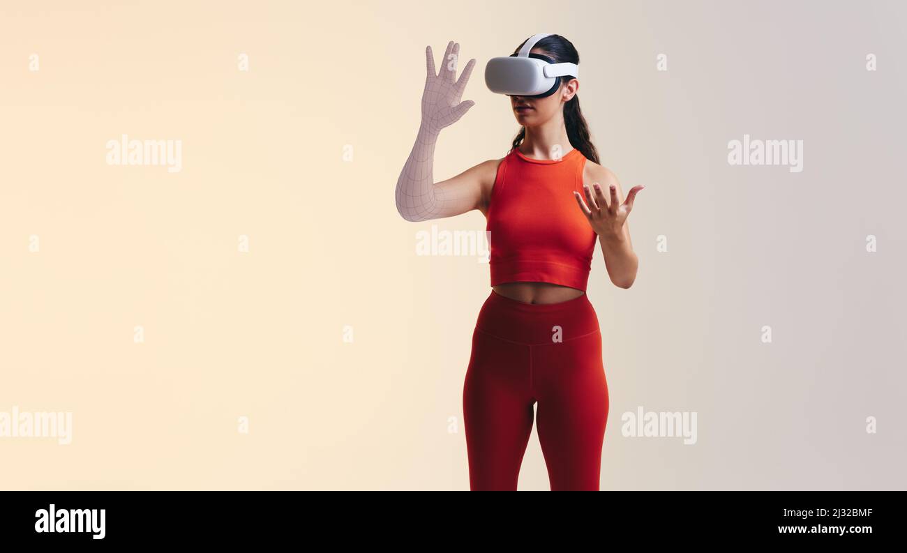 Becoming a part of the metaverse. Young woman transforming into an ...