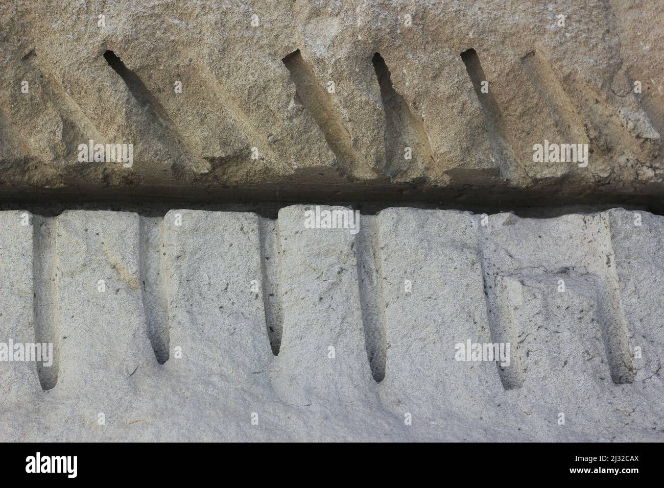 Deconstructed concrete slabs with boring holes and fitted on top of ...