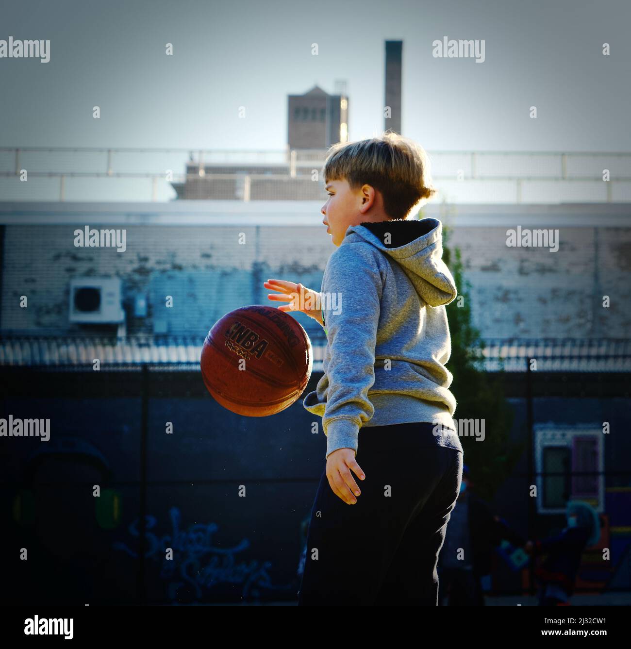 Kid dribbling ball playing basketball hi-res stock photography and ...