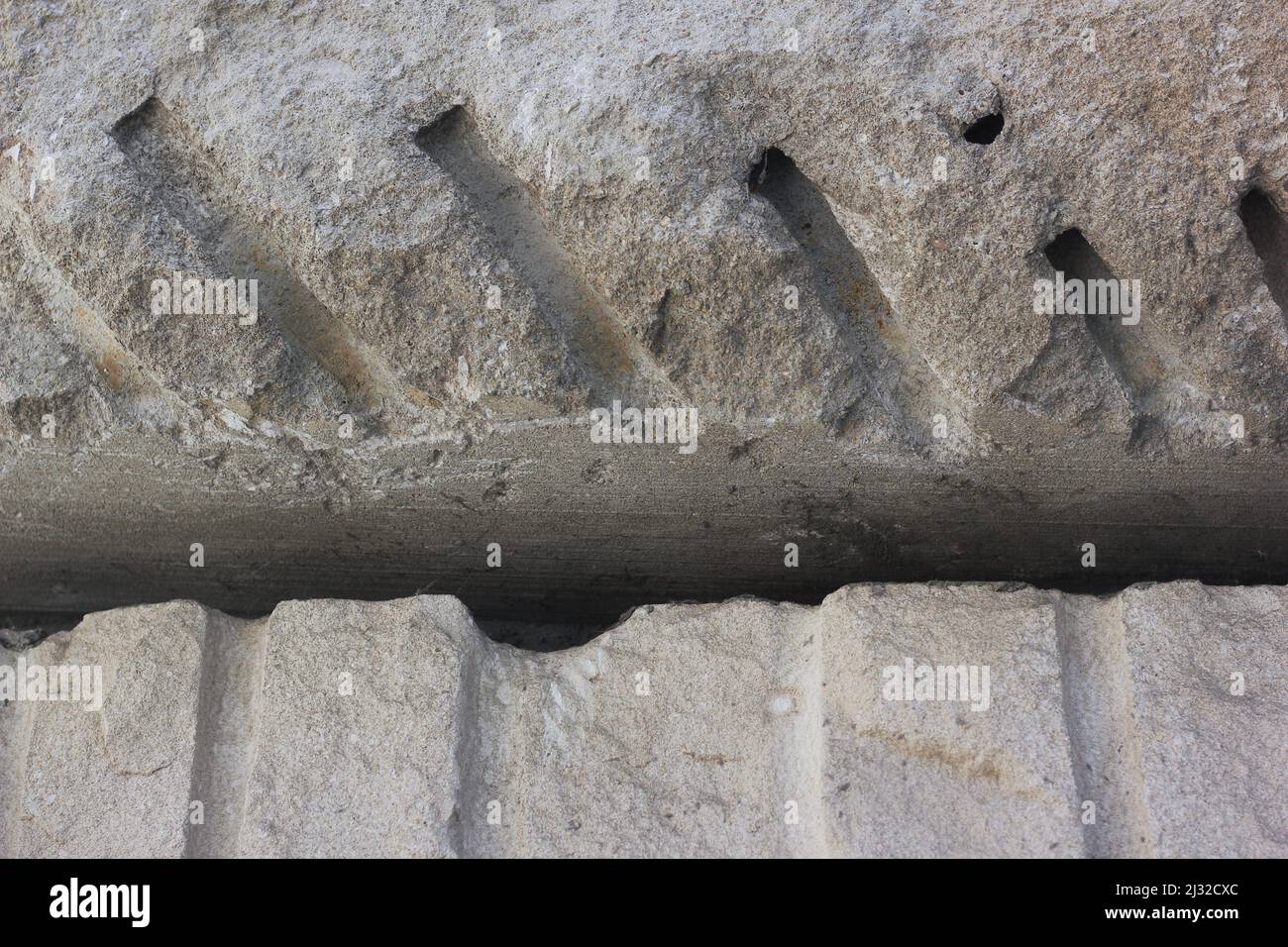 Deconstructed concrete slabs with boring holes and fitted on top of ...