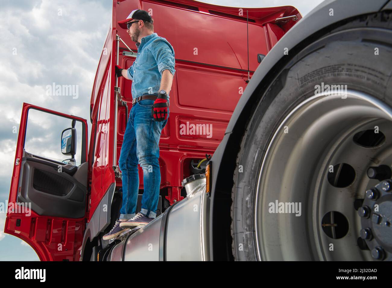 Professional Caucasian Driver in His 30s Standing on a Semi Tractor ...