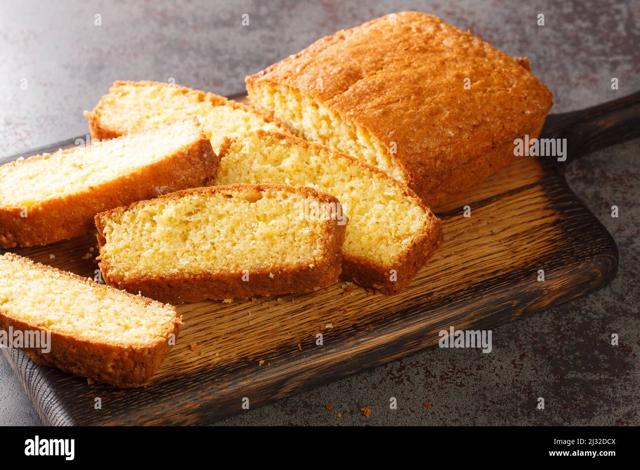 Tasty Madeira sponge cake closeup served on a wooden cutting board on ...
