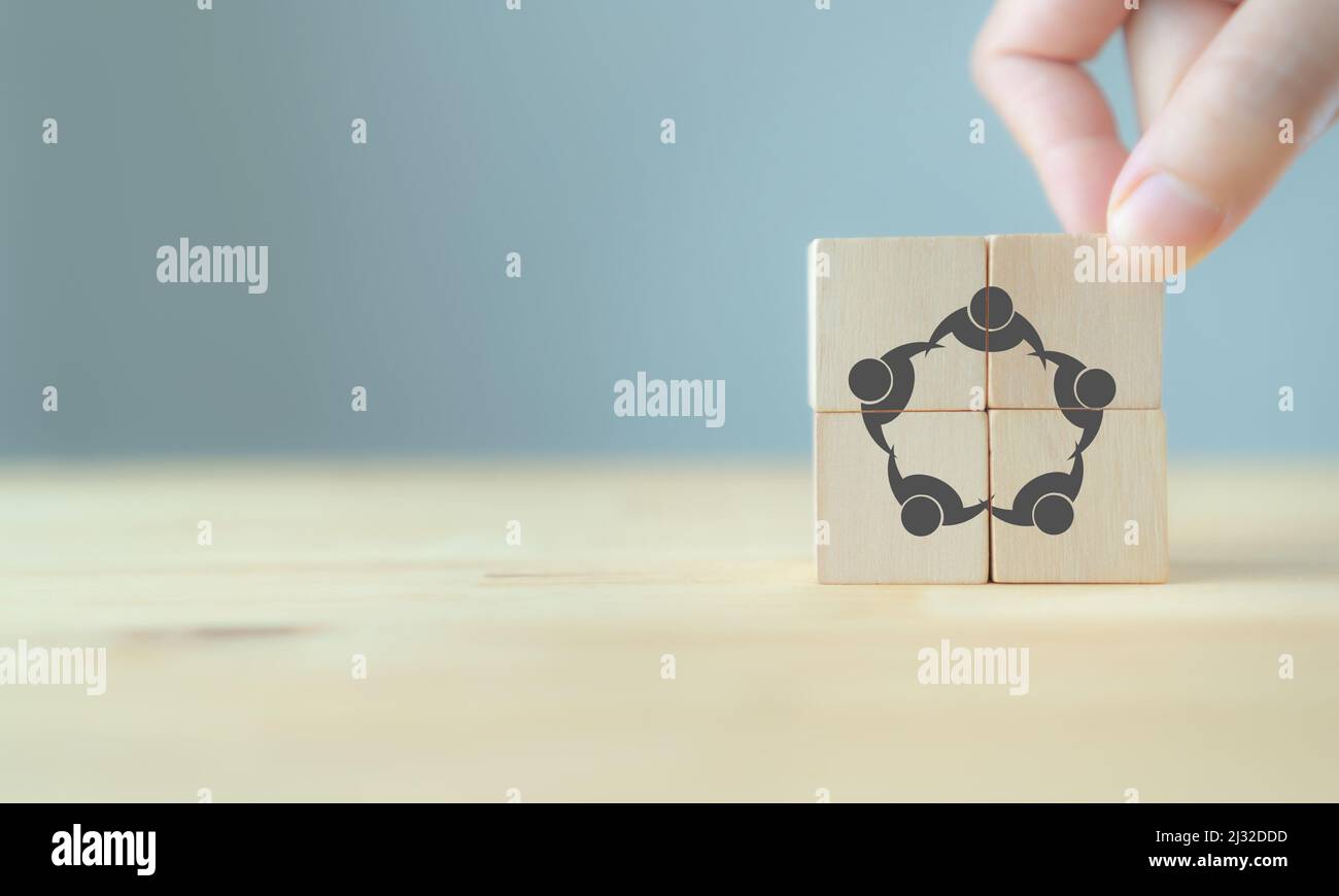 Business management concept; teamwork, collaboration, achieve a common goal. Wooden cube ...
