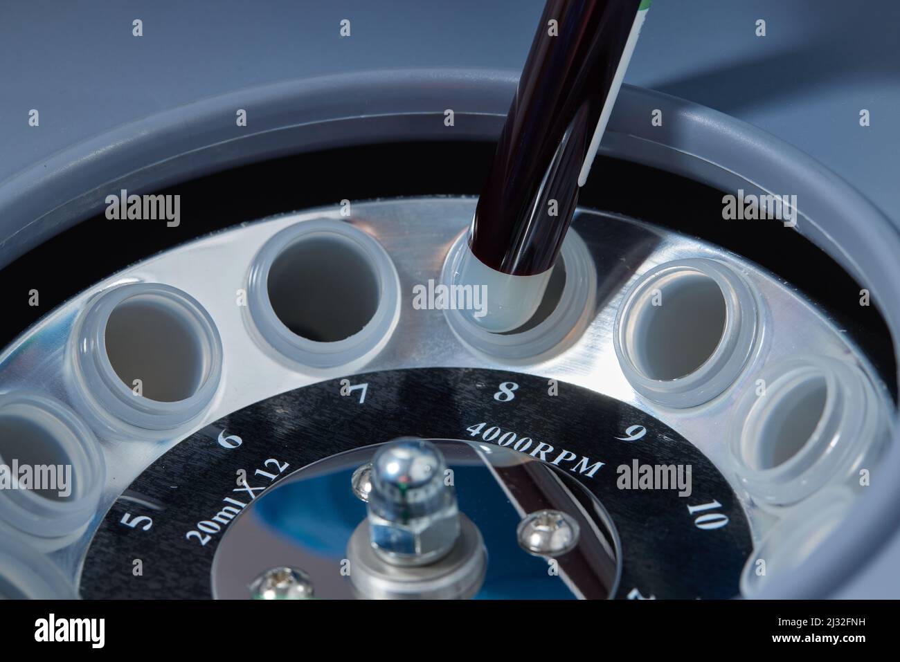 Beautician doctor's hands put test tube with blood in centrifuge ...