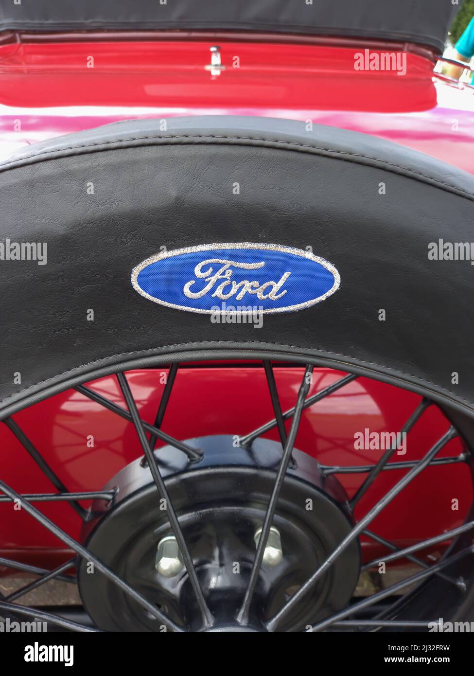 Ford oval emblem logo and branding on spare wheel cover of an old Model ...