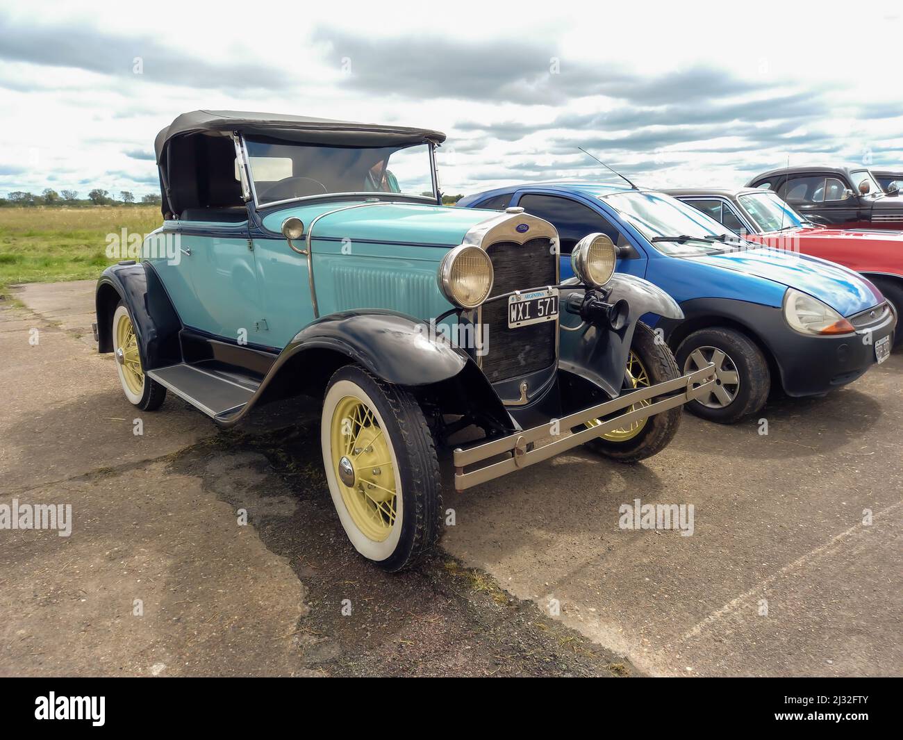 Old cyan Ford Model A coupe roadster circa 1930 parked at an airstrip ...