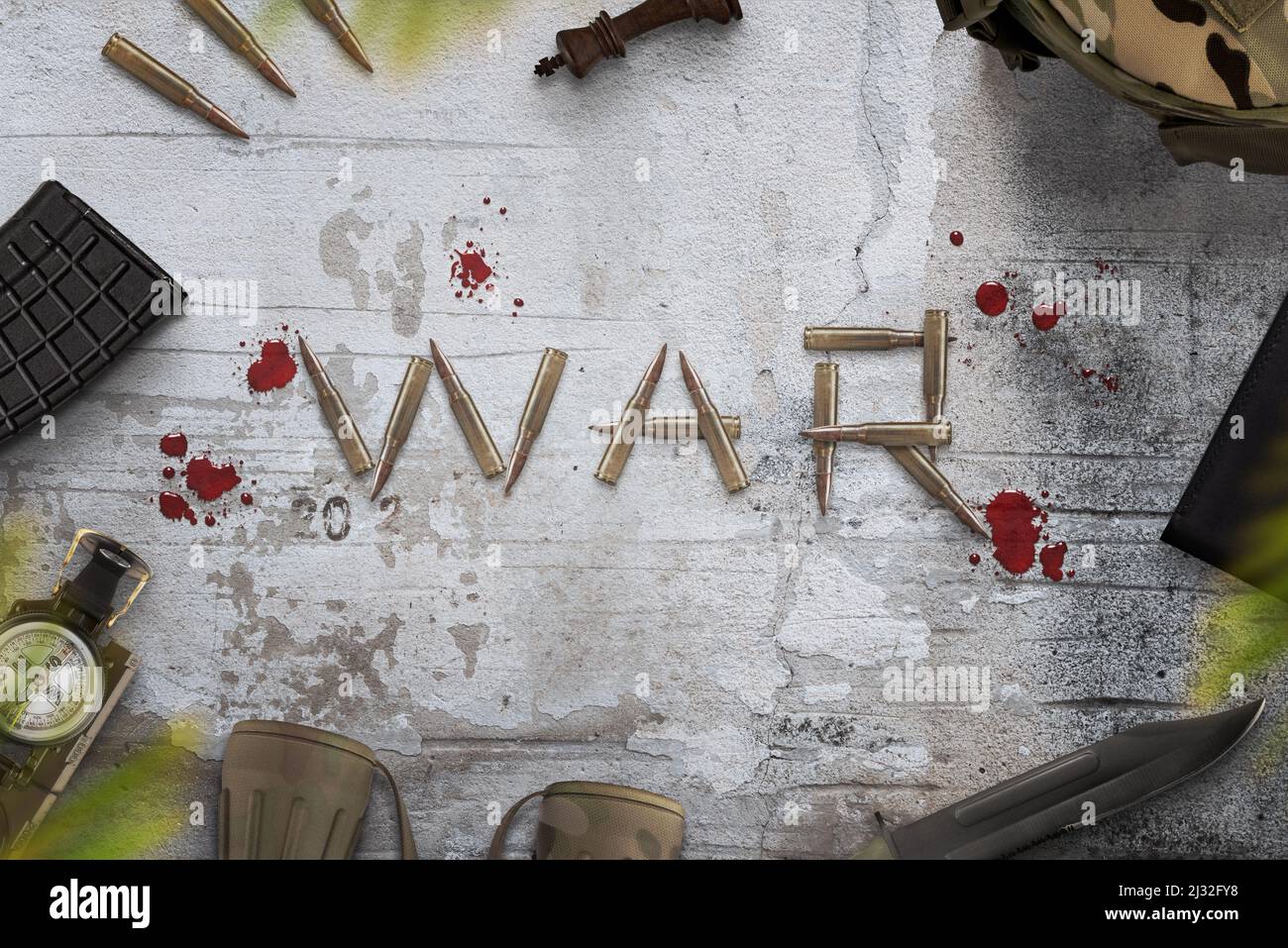 War composition on rough surface writen with bullets and surrounded ...