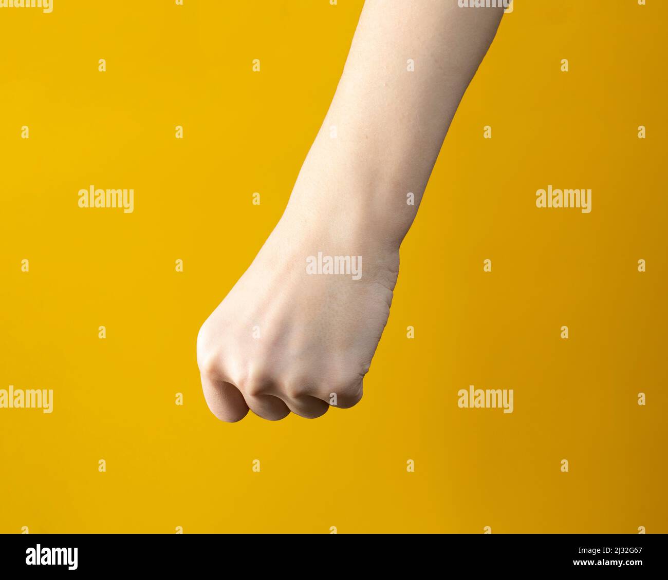 Hand of caucasian woman on yellow background doing protest and ...