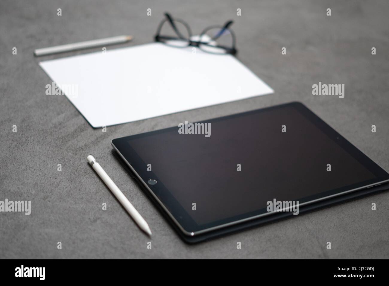 A black tablet on a concrete table Stock Photo - Alamy
