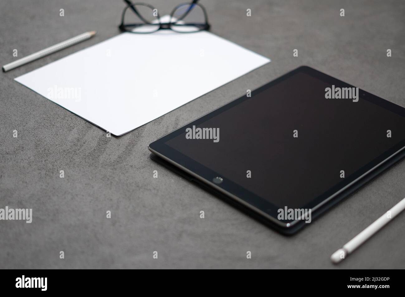 A black tablet on a concrete table Stock Photo - Alamy