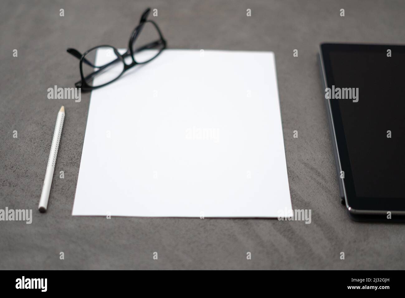 A black tablet on a concrete table Stock Photo - Alamy