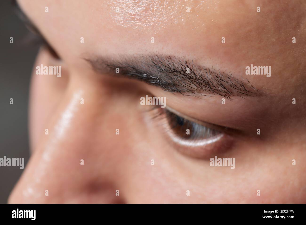 Professional barber doing threading procedure and correcting shape of ...