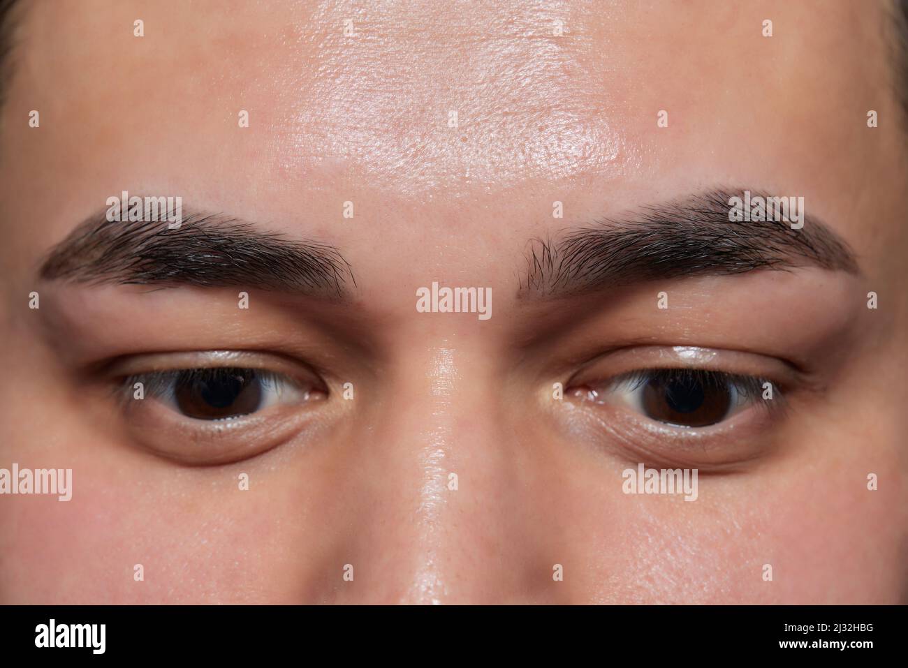 Professional barber doing threading procedure and correcting shape of ...