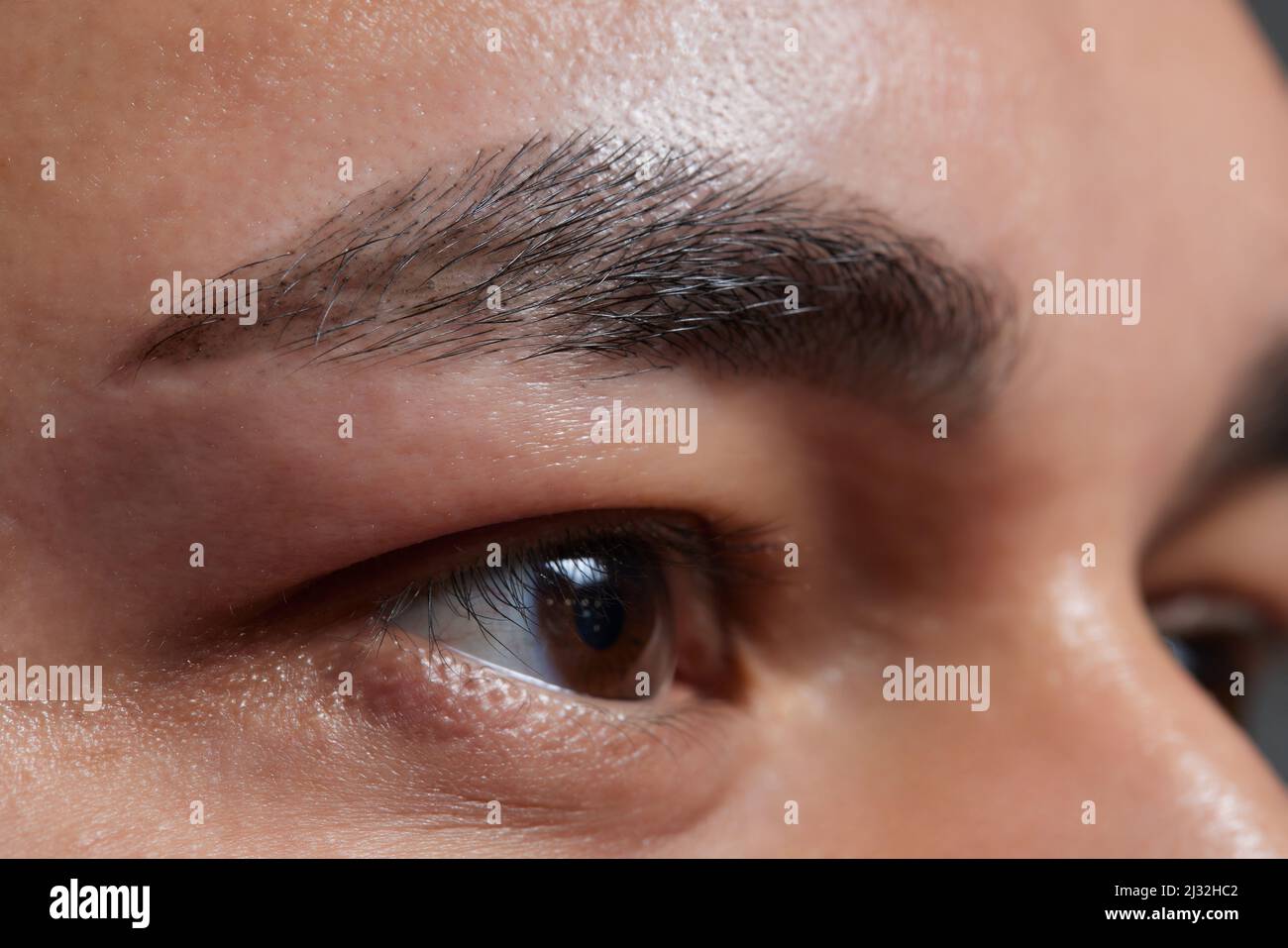 Professional barber doing threading procedure and correcting shape of ...