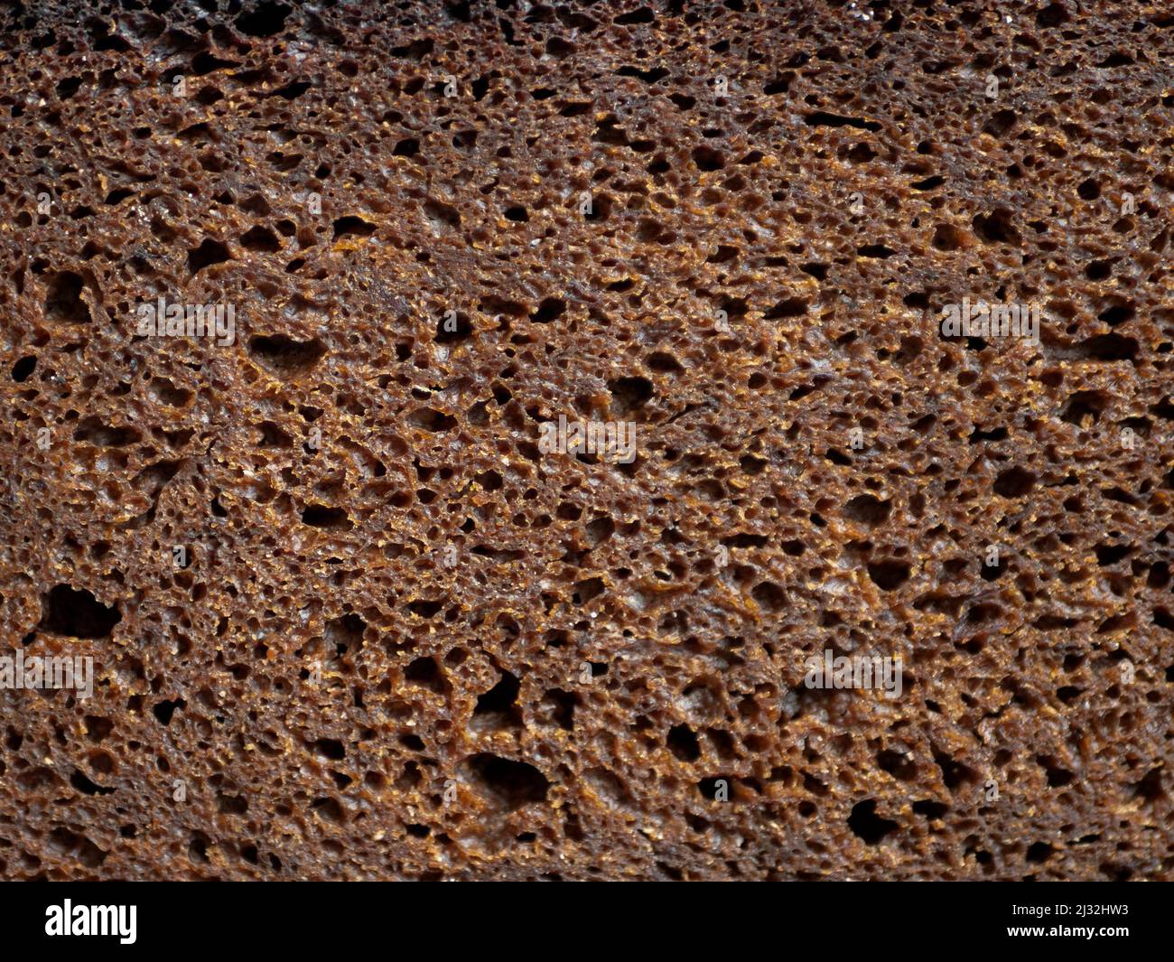 Piece of brown rye bread, close up. Bread slice texture background ...