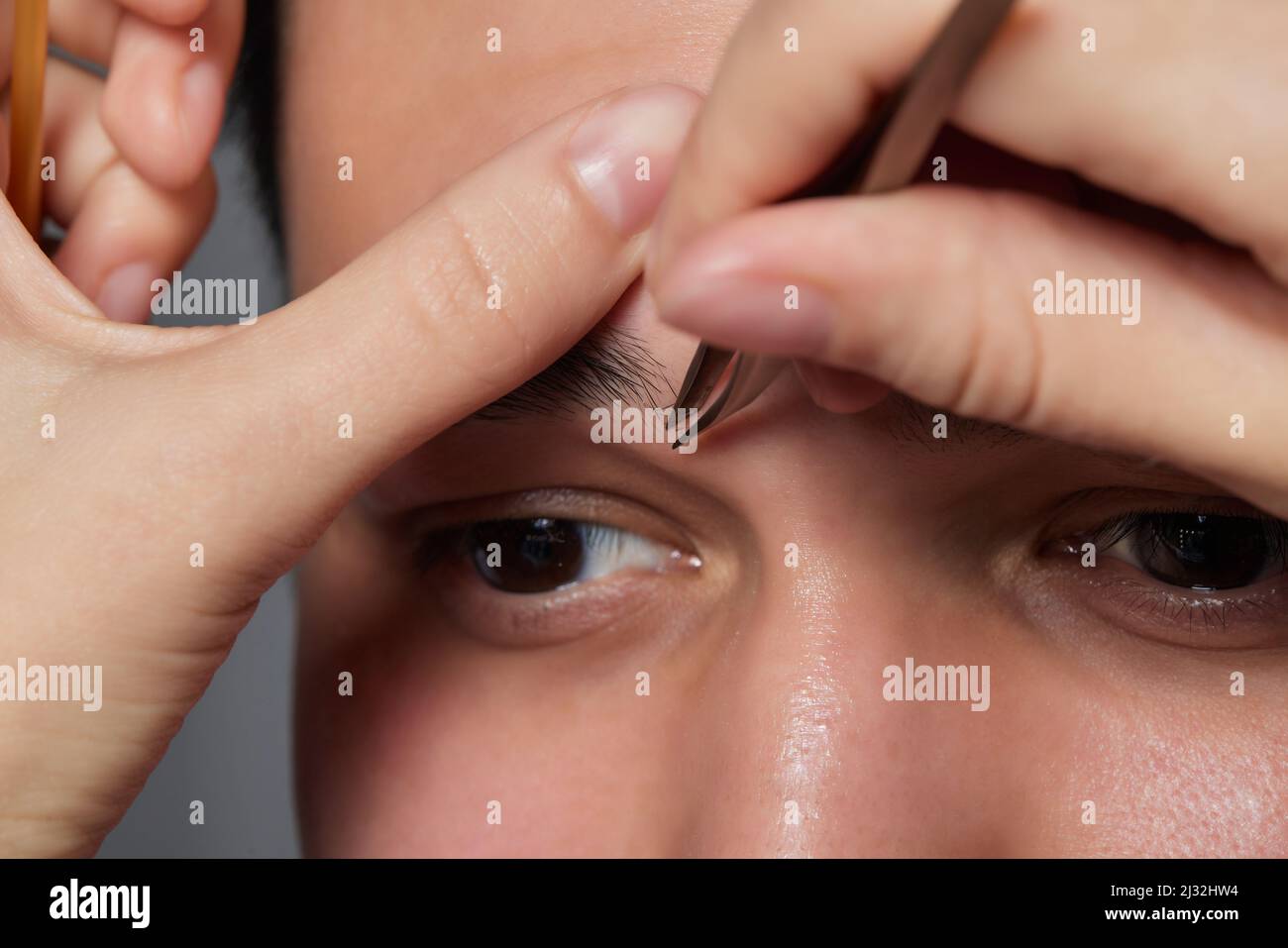 Professional barber doing threading procedure and correcting shape of ...