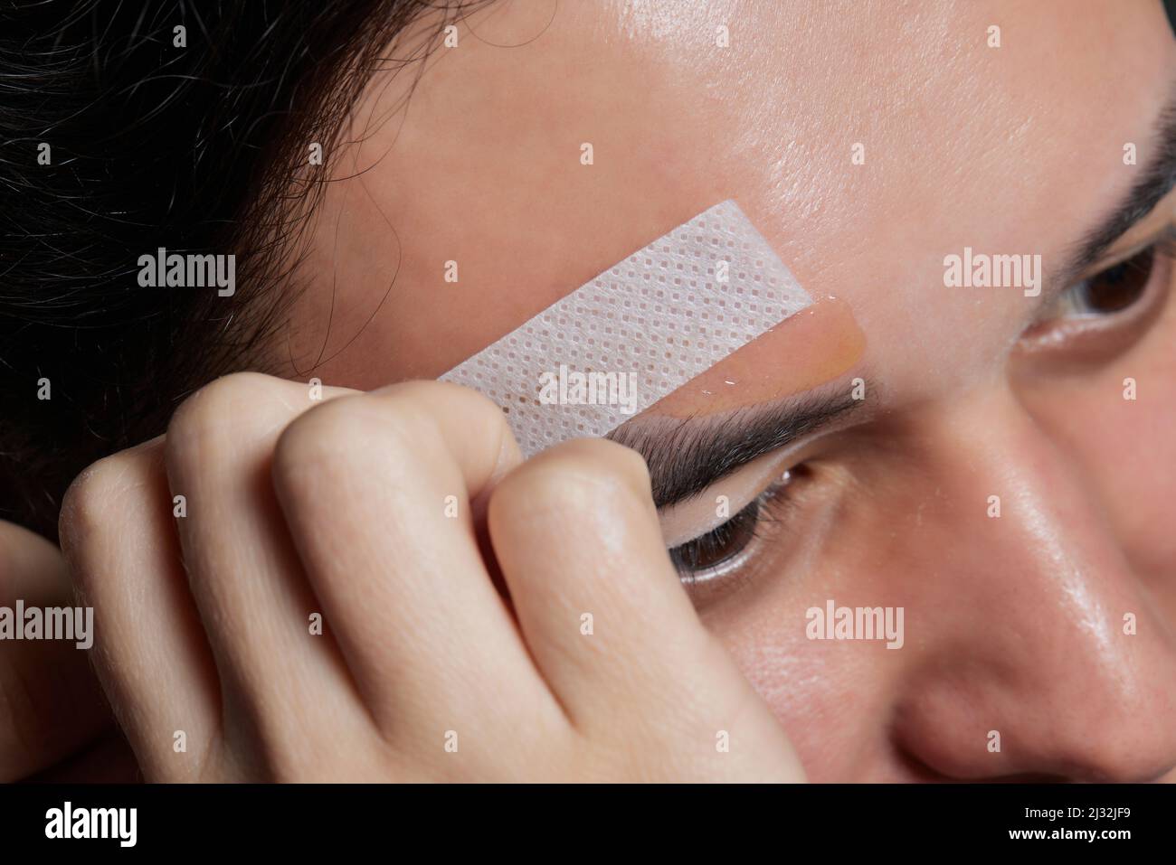 Professional barber doing threading procedure and correcting shape of ...