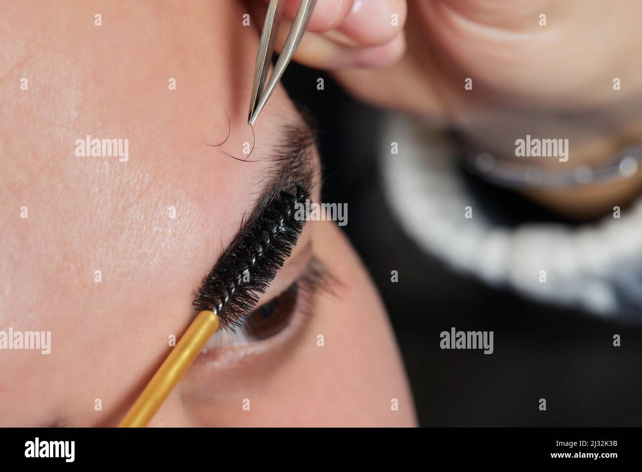 Professional barber doing threading procedure and correcting shape of ...