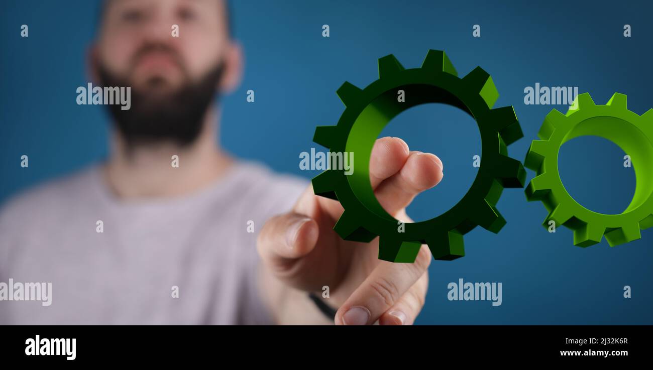 A 3d rendered metallic gears and cogs in mans hand Stock Photo - Alamy
