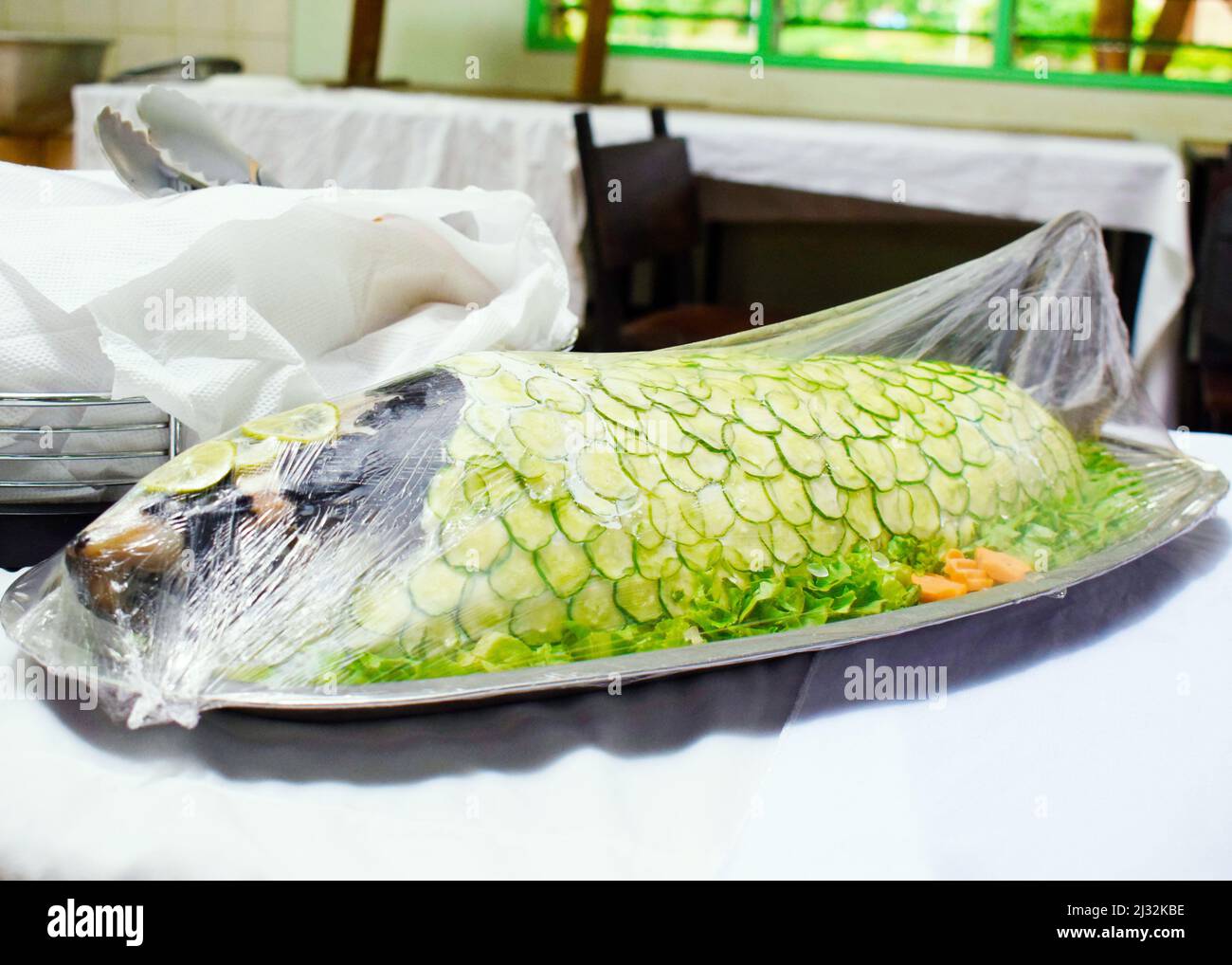 Menu starter, consisting of fish covered with fresh vegetables in the ...