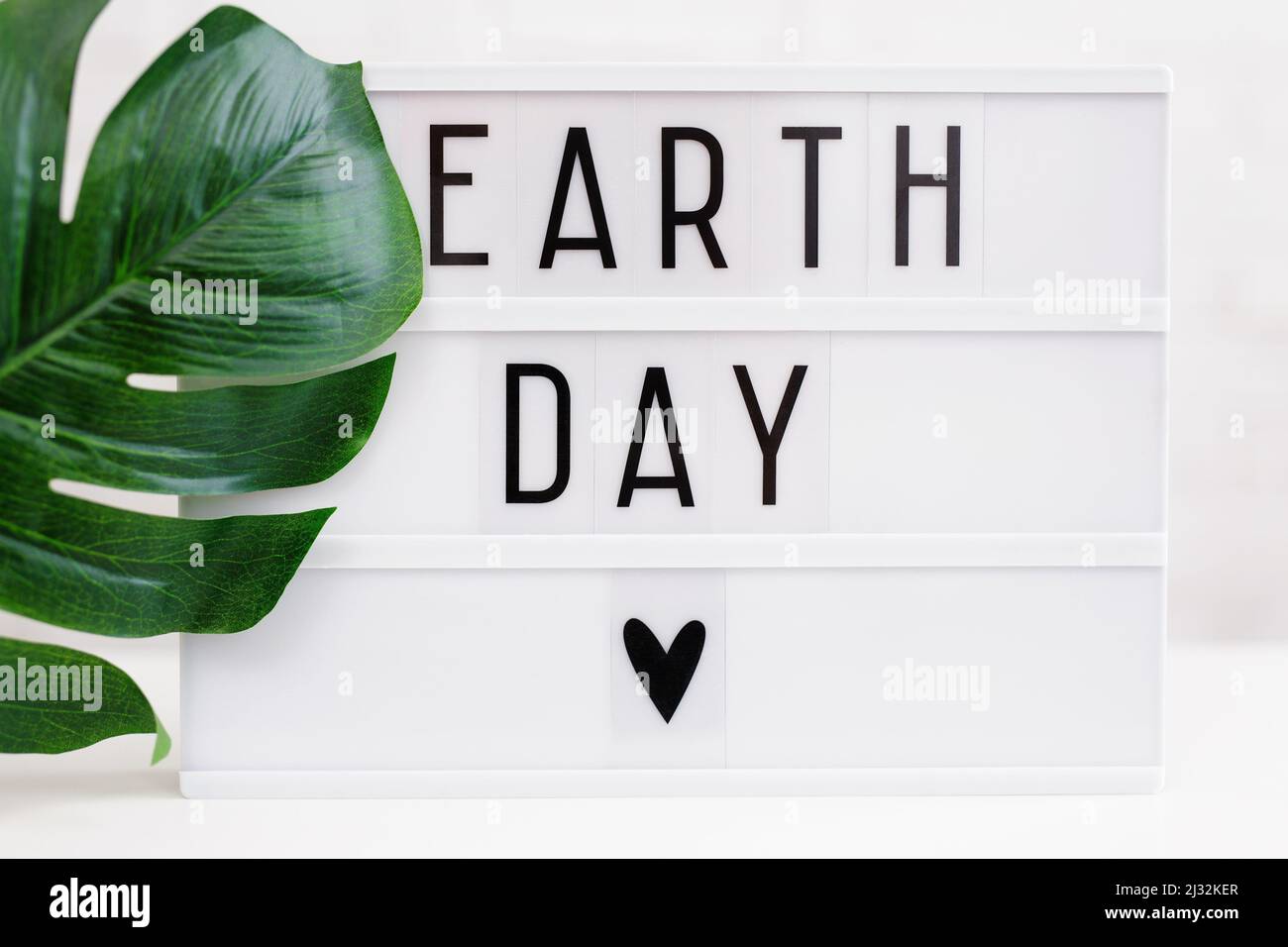 Earth day concept - close up of lightbox with earth day words and green ...