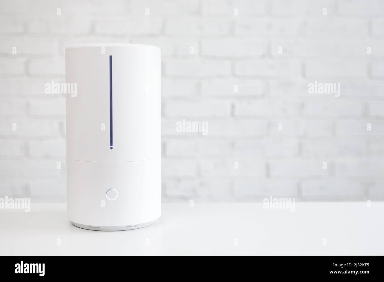modern air humidifier over white brick wall background with copy space ...