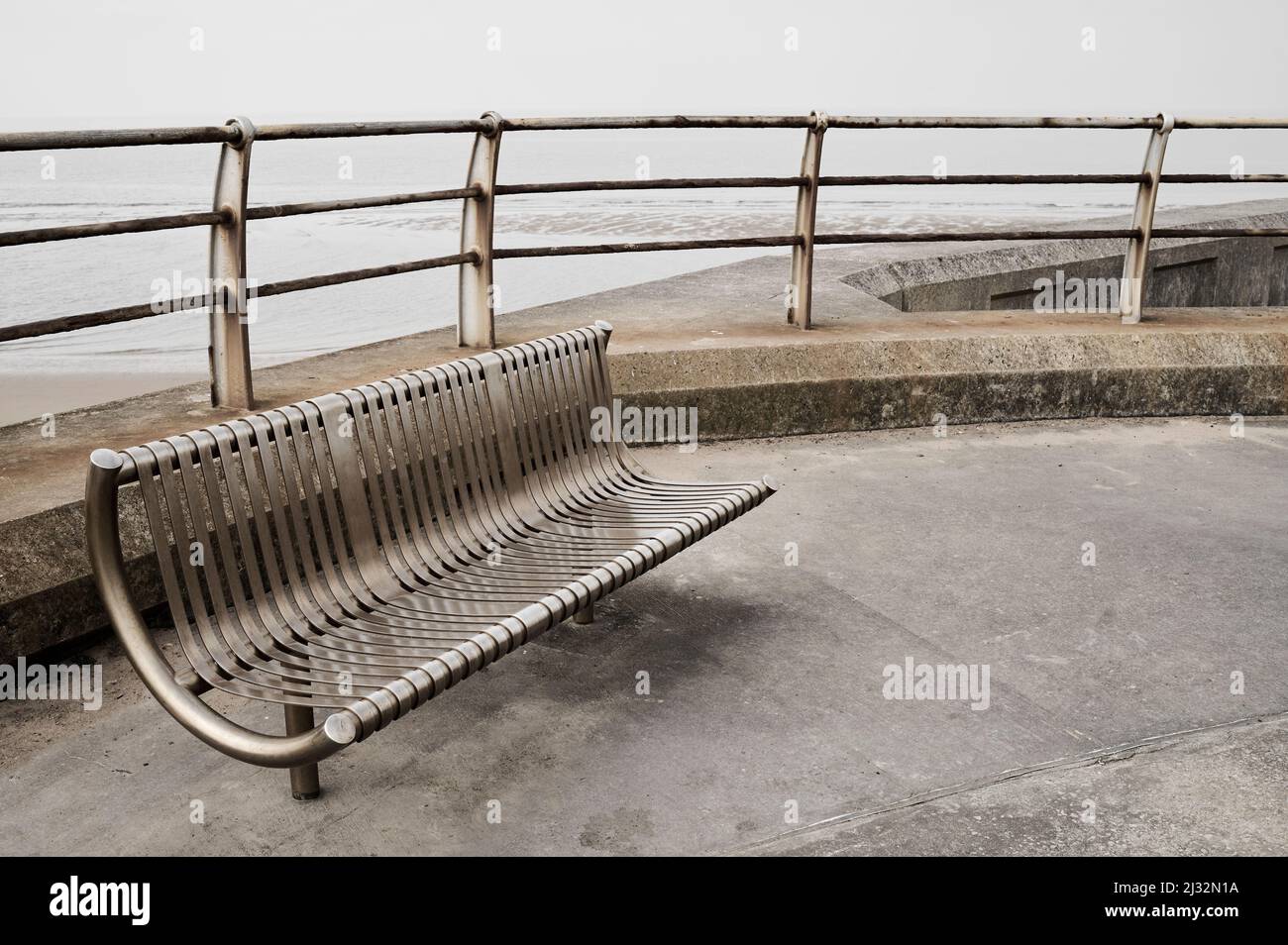 Metal seaside bench,railings and Beach Stock Photo - Alamy