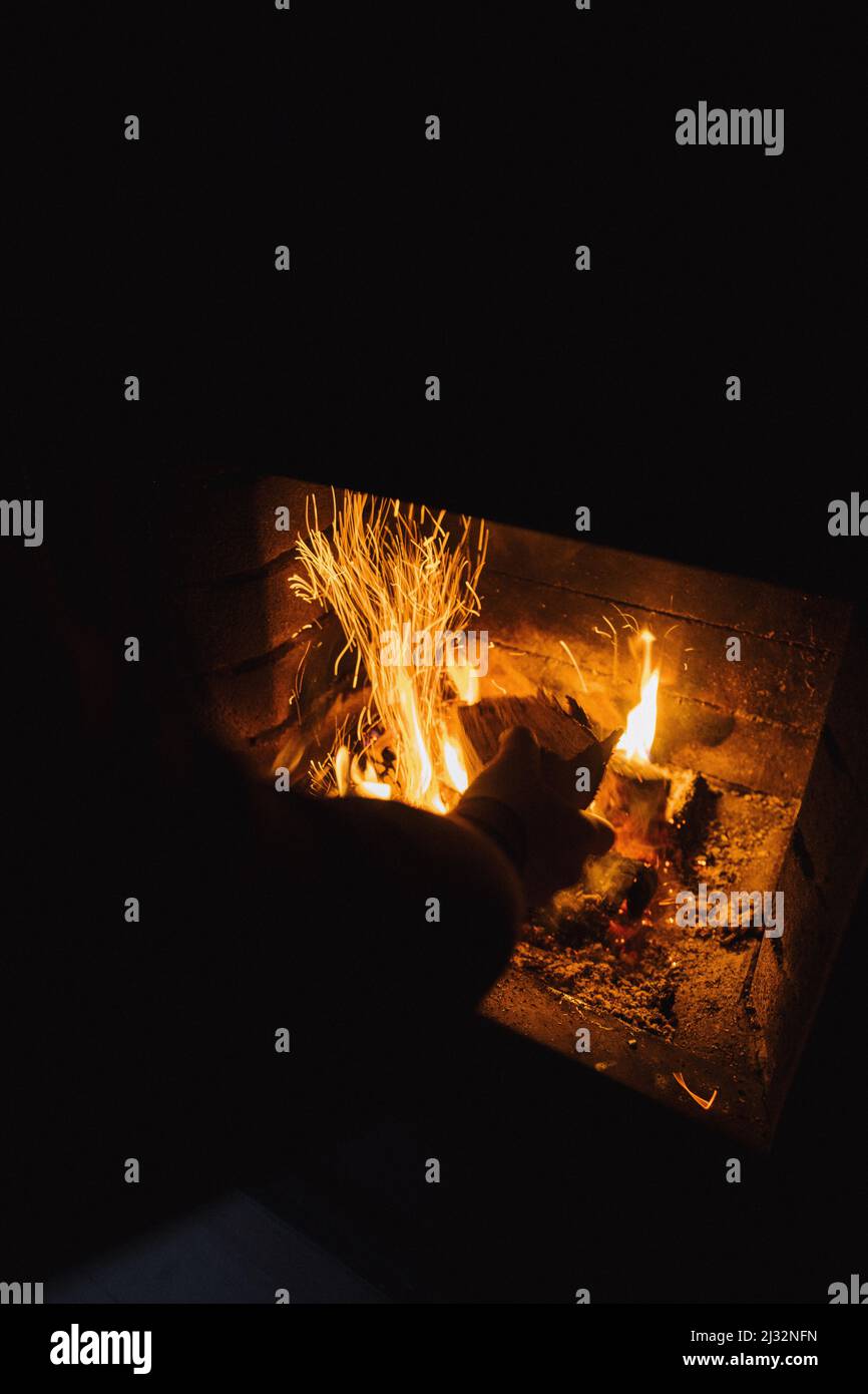 Fireplace adding wood fire hi-res stock photography and images - Alamy