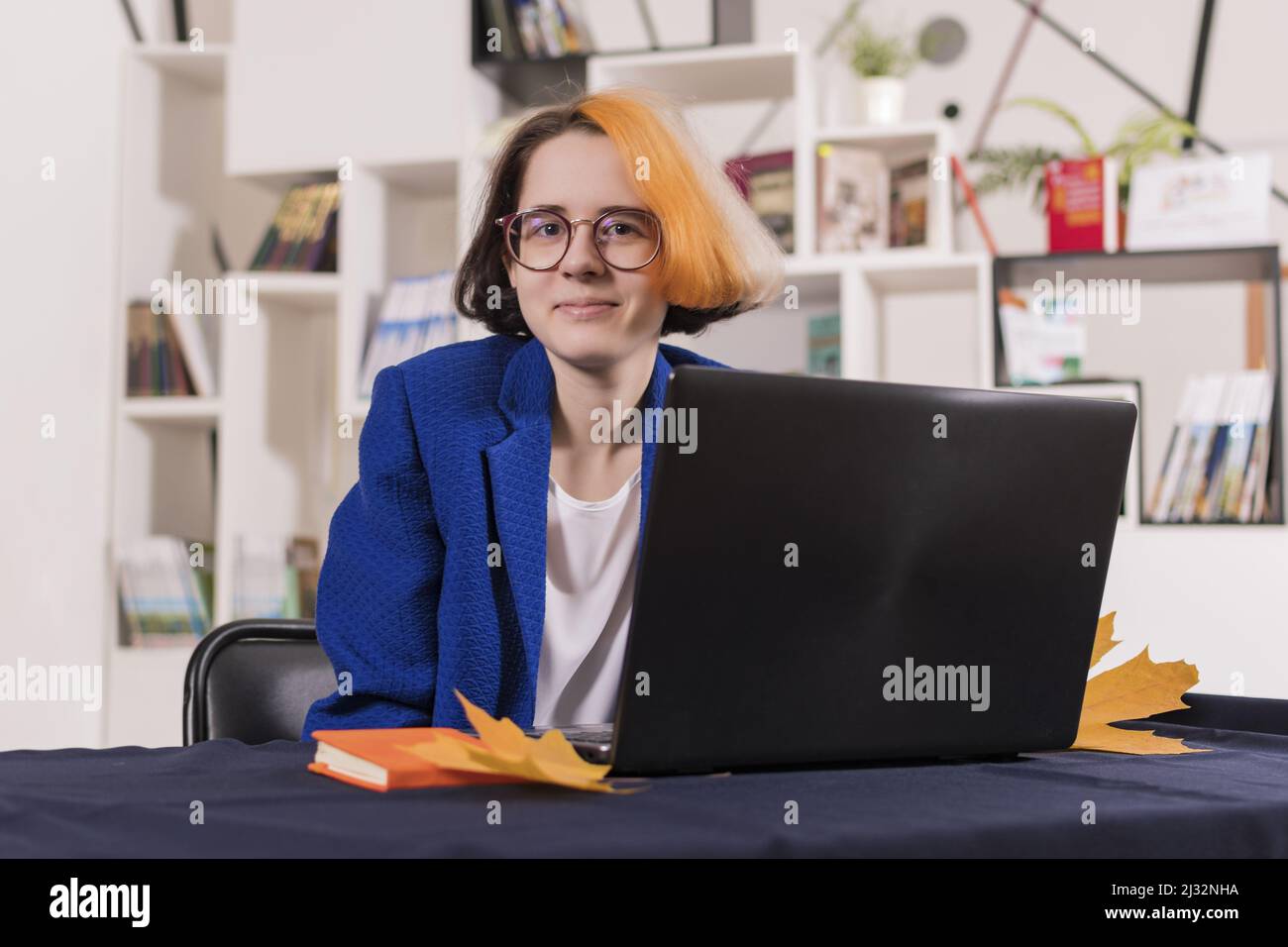 Young girl, secretary, in business suit with multi-colored hair and ...