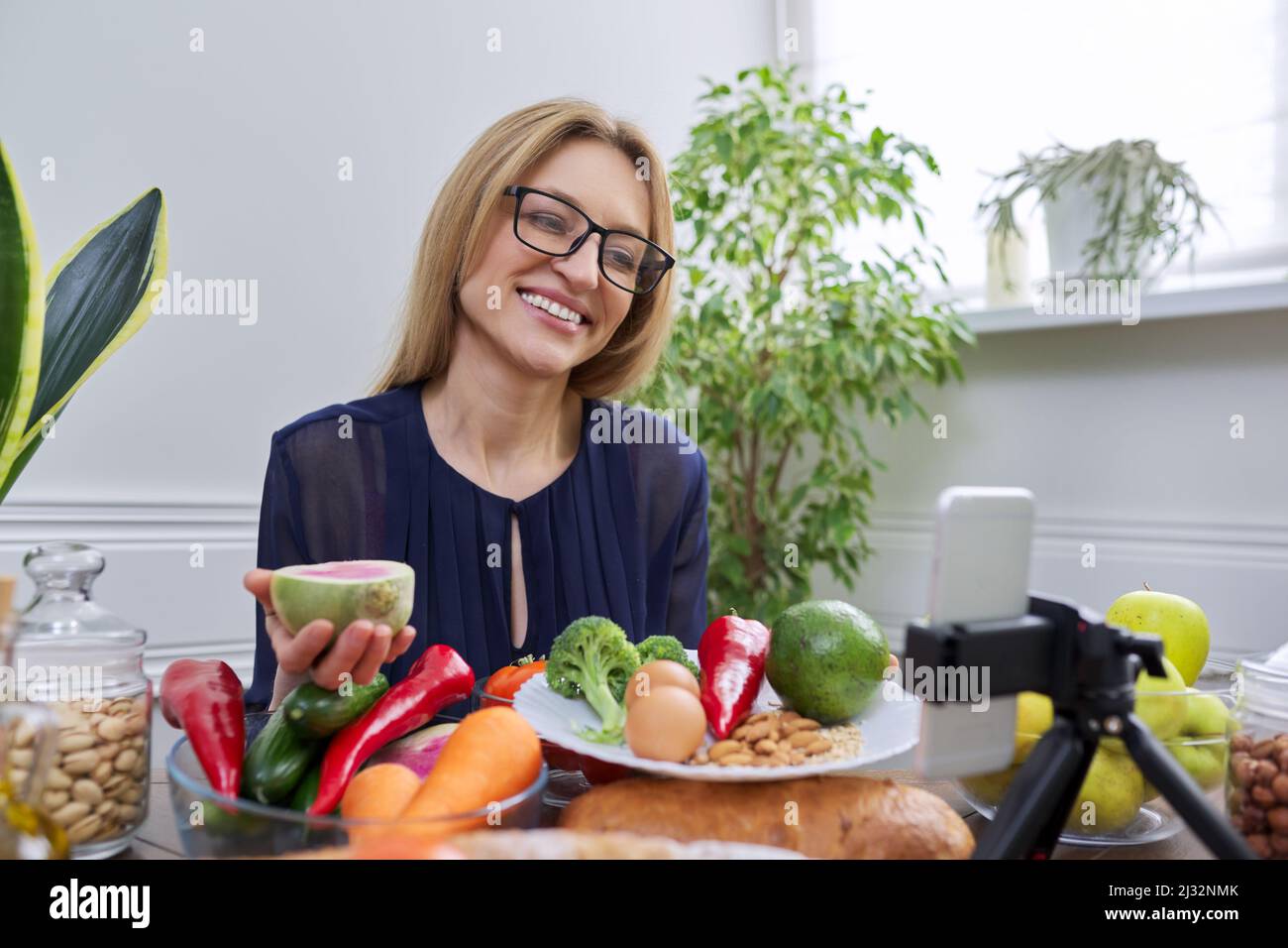 Woman telling and showing healthy food, vegetables fruits nuts eggs ...