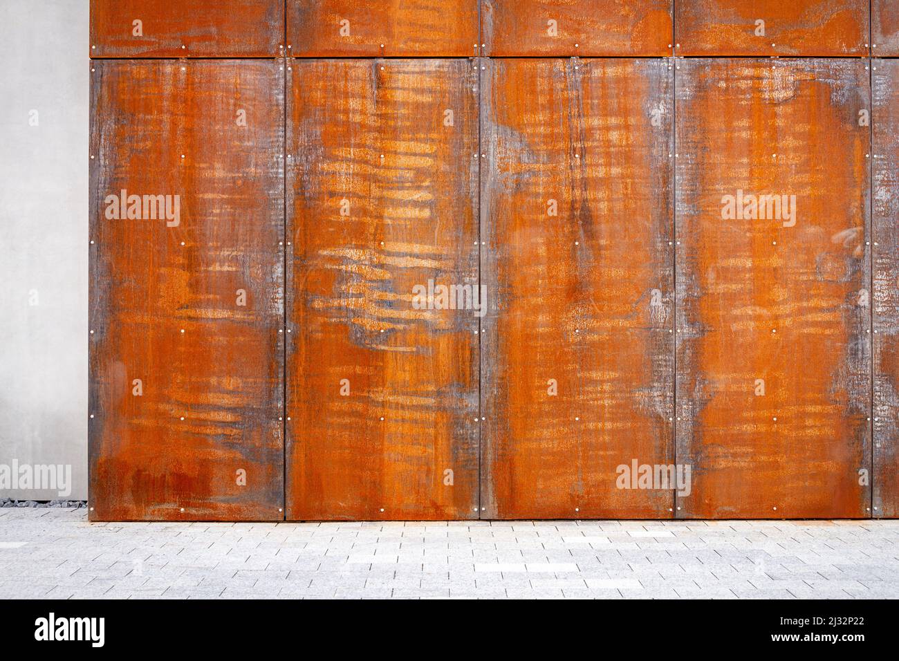 Modern architecture rusty metal and concrete wall with a sidewalk Stock ...