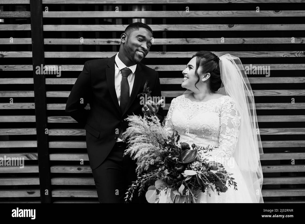 Portrait of overjoyed couple on wedding day, beautiful bride with ...