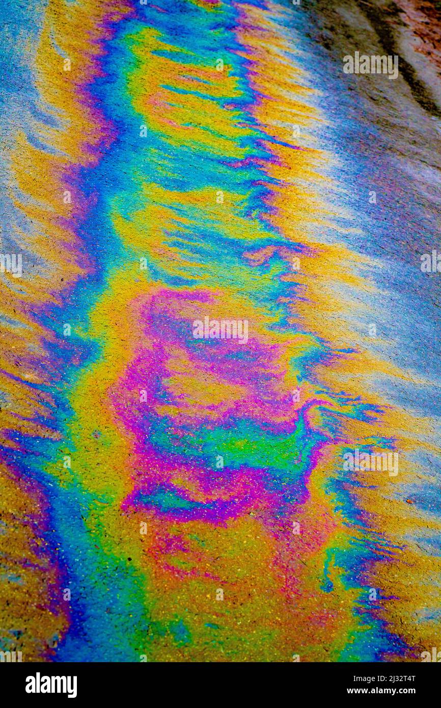 Many Colours produced by an oil leak on a wet road Stock Photo - Alamy