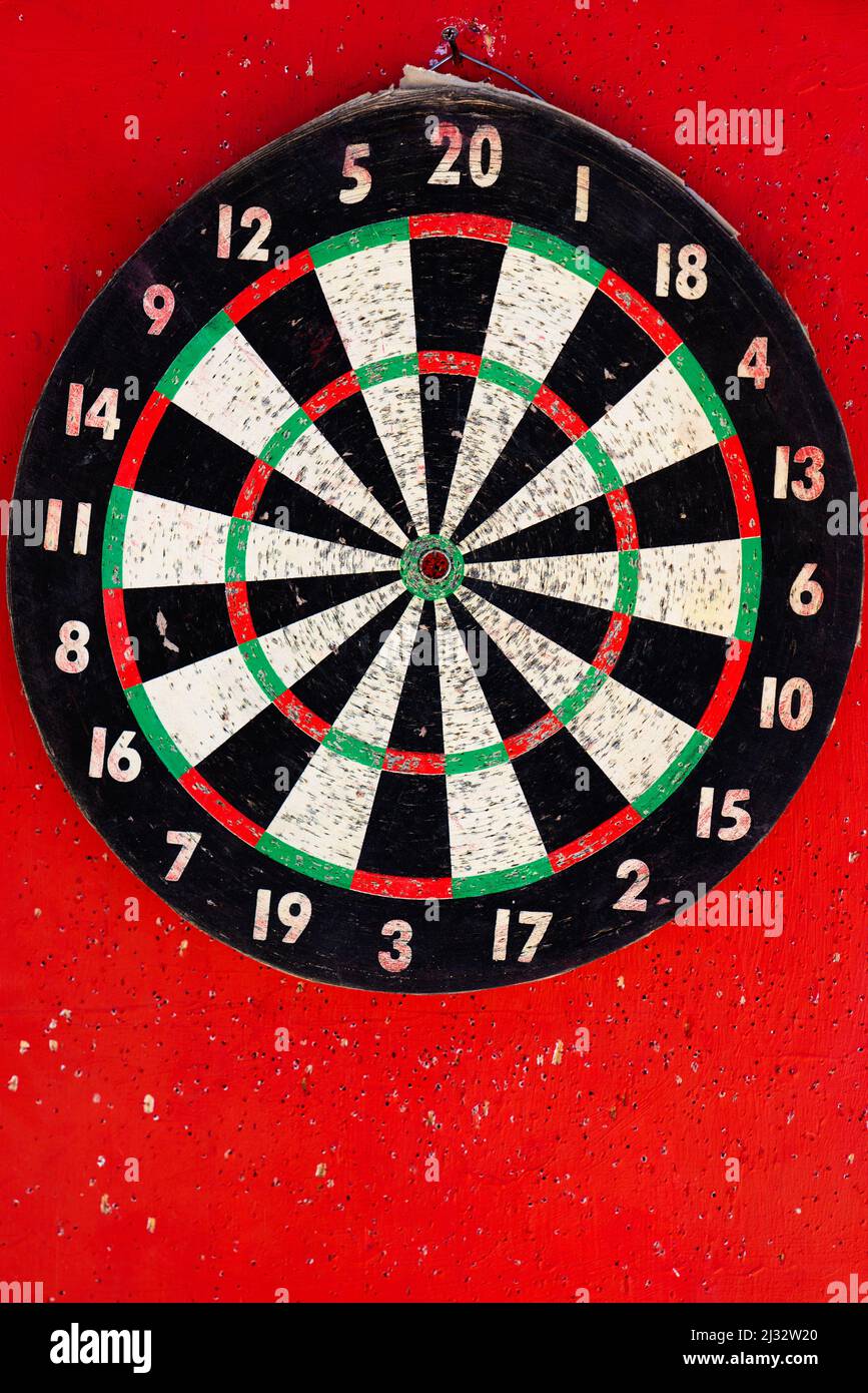 The target of the game of darts on a red background. Concept of success ...