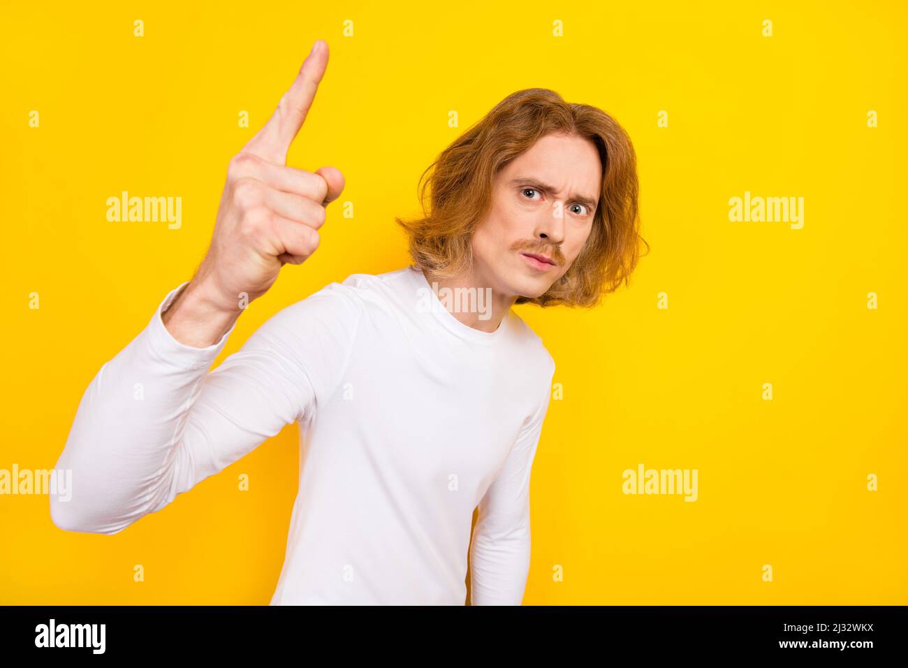 Photo of male with grumpy serious expression point finger empty space ...