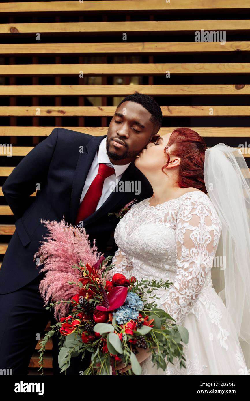 Portrait of happy couple, beautiful bride cuddle with charming groom ...