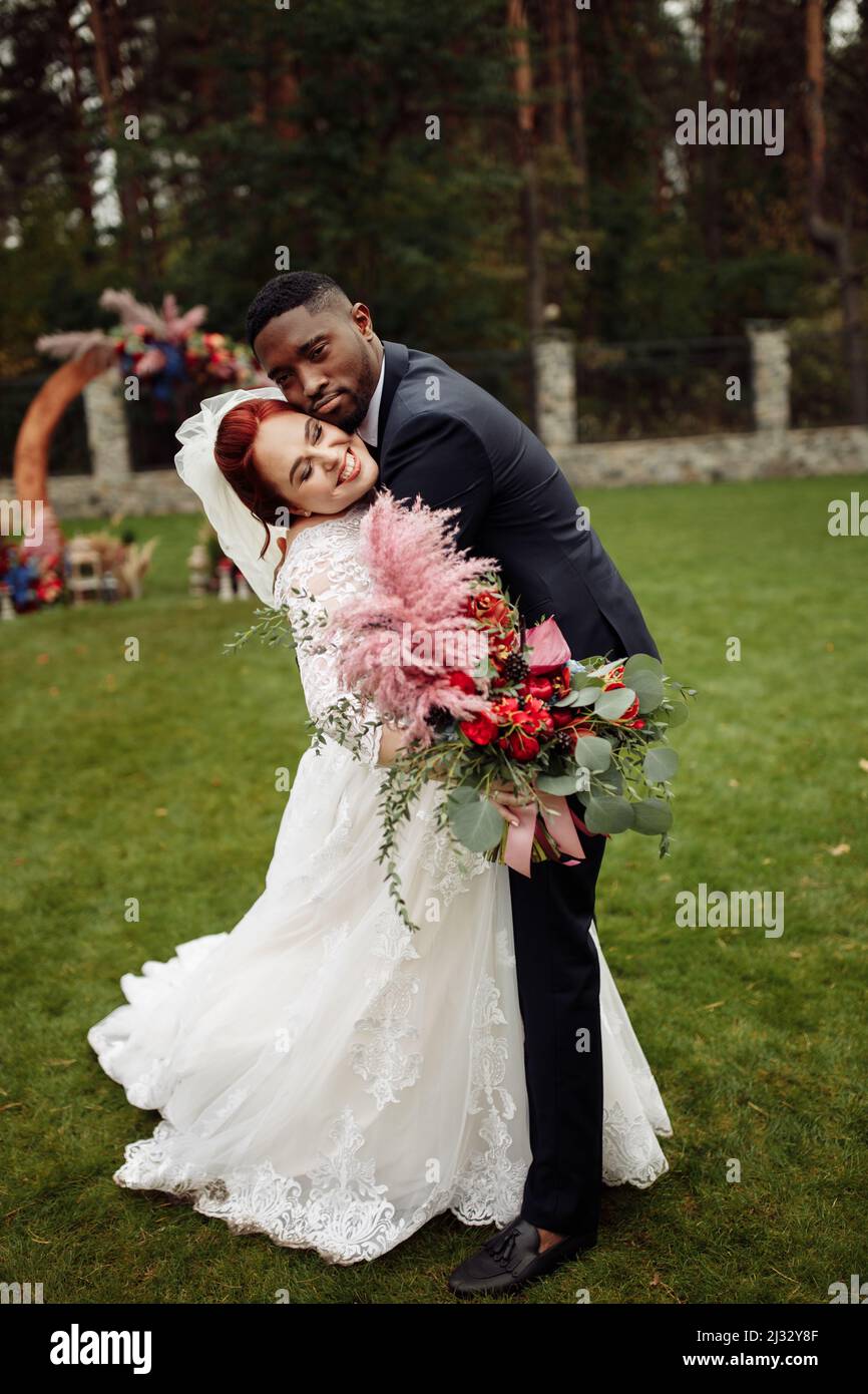 Portrait of happy couple, beautiful bride cuddle with charming groom ...