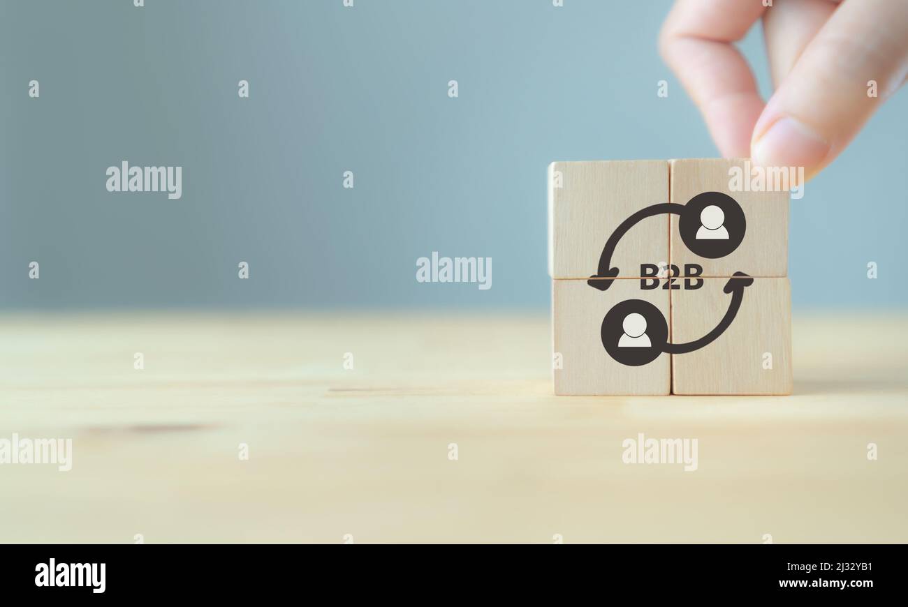 Business to business, B2B, BTB marketing concept. Hand hold the wooden ...