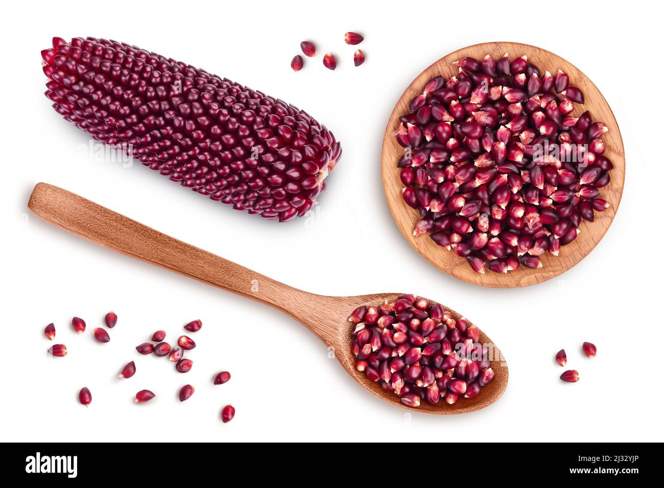 Purple corn or maize seeds in wooden bowl isolated on white background ...
