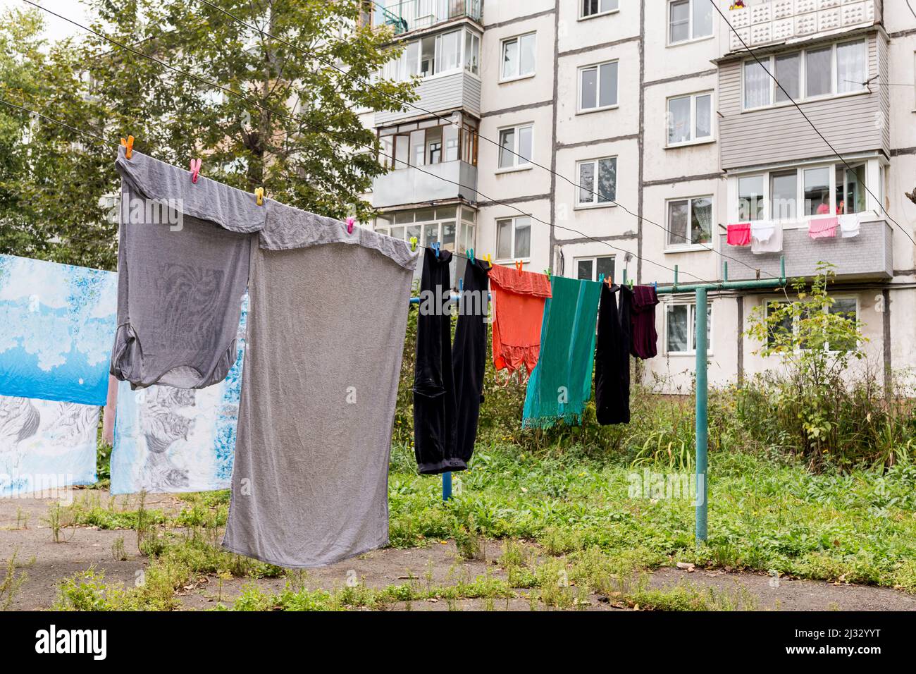 Laundry dries on the rope in courtyard of Khrushchyovka. Khrushchyovka ...