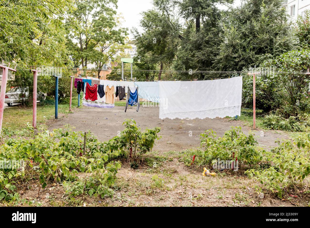 Laundry dries on the rope in courtyard of Khrushchyovka. Khrushchyovka ...