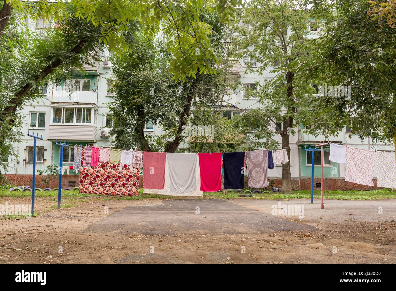 Laundry dries on the rope in courtyard of Khrushchyovka. Khrushchyovka ...