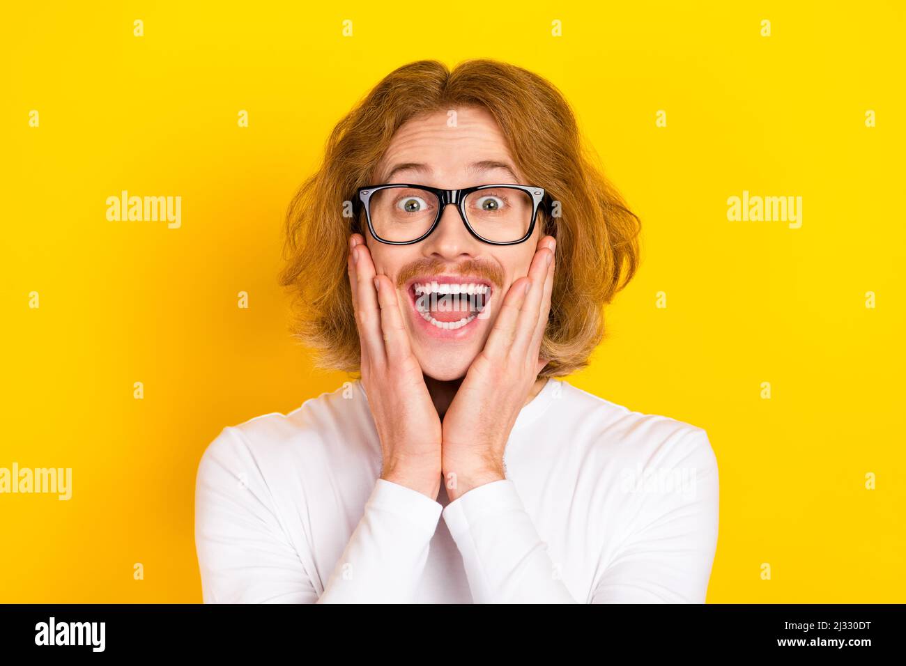 Photo Of Excited Funky Guy Wear White Shirt Spectacles Arms Cheeks